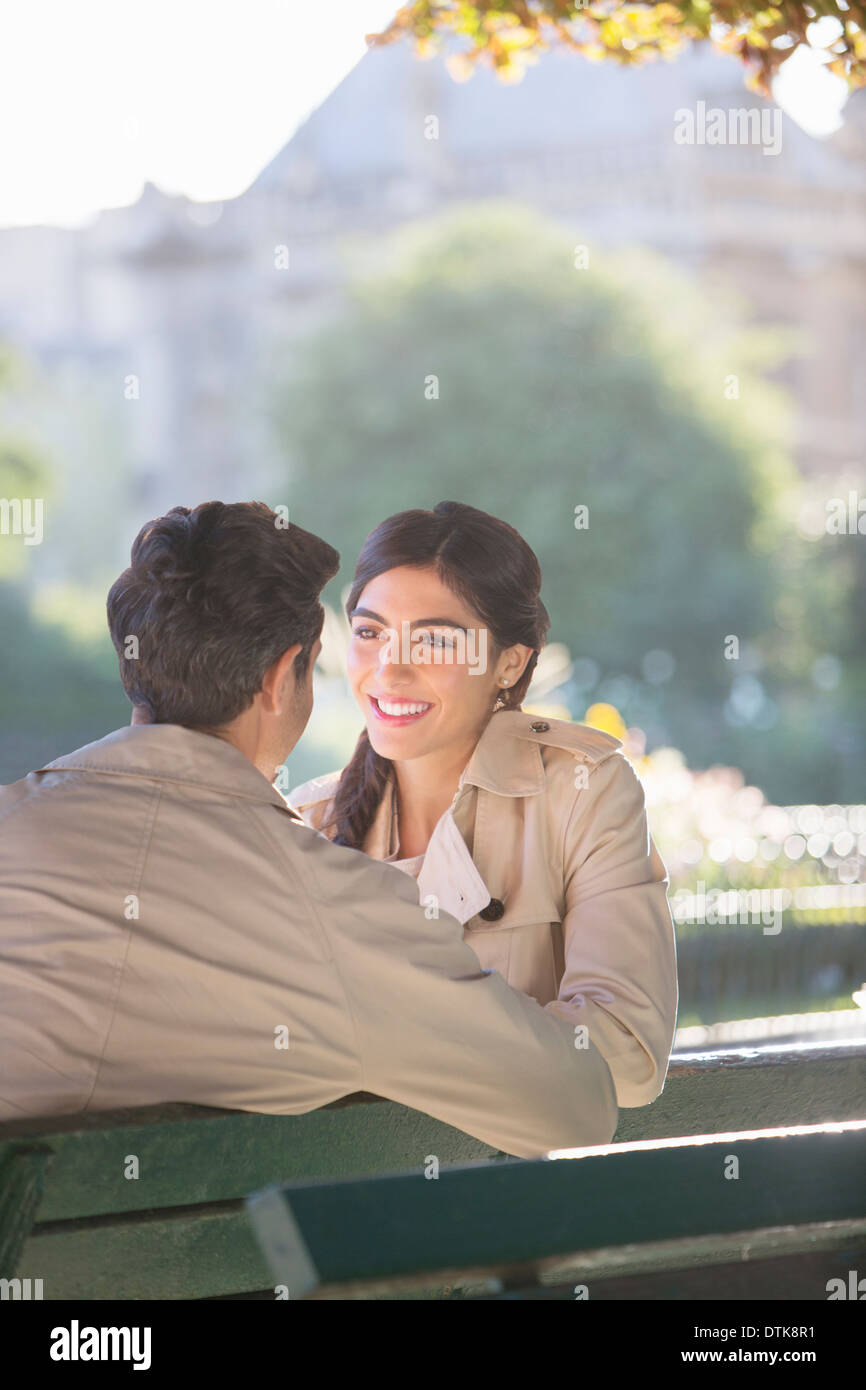 Couple talking on park bench Stock Photo - Alamy