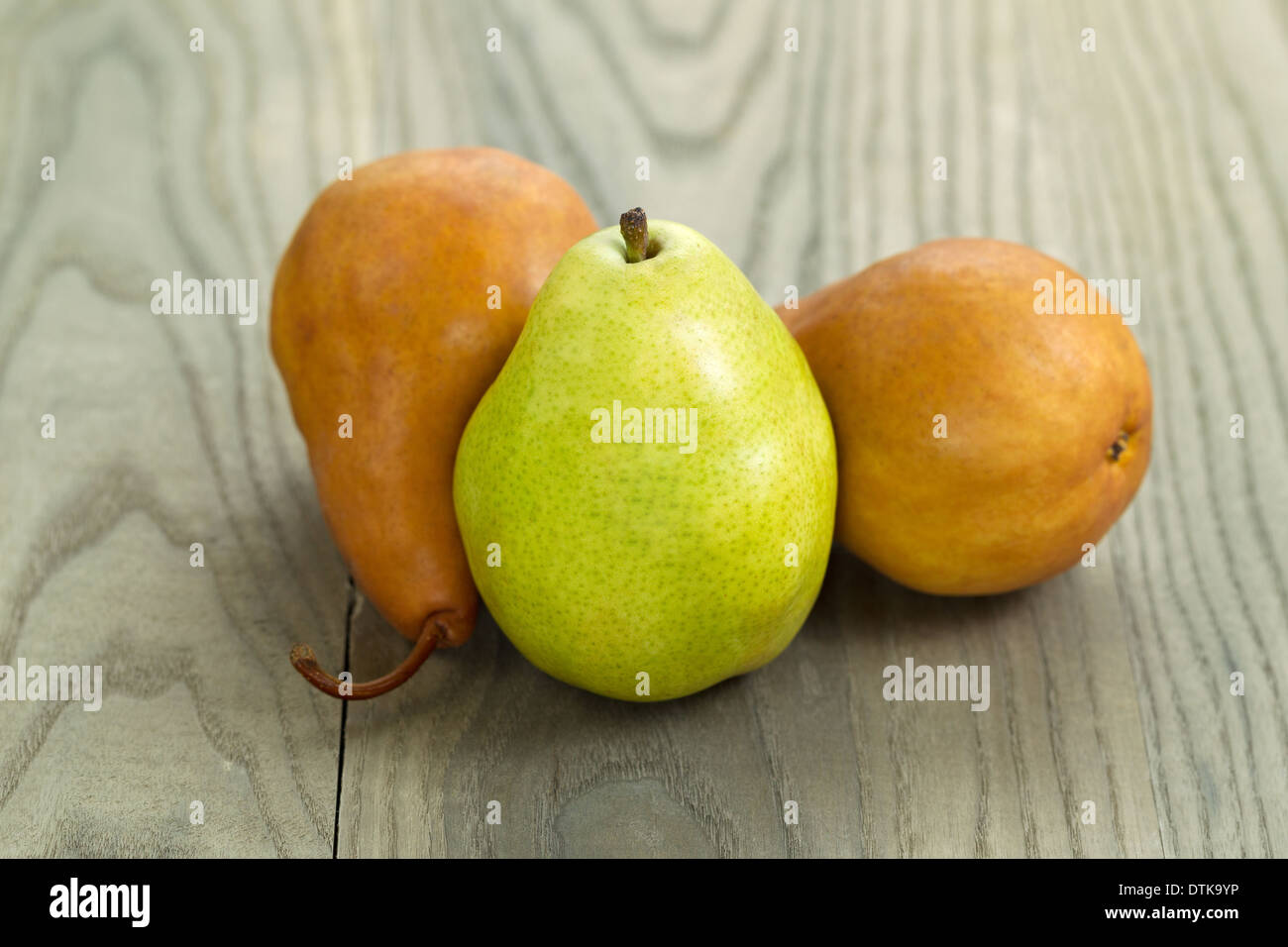 Horizontal photo of one Green and two brown pears on aged wood Stock ...