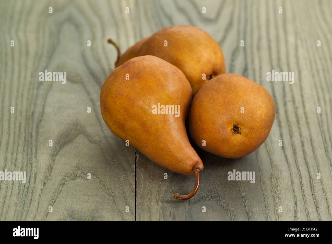 Horizontal photo of three brown pears on aged wood Stock Photo - Alamy