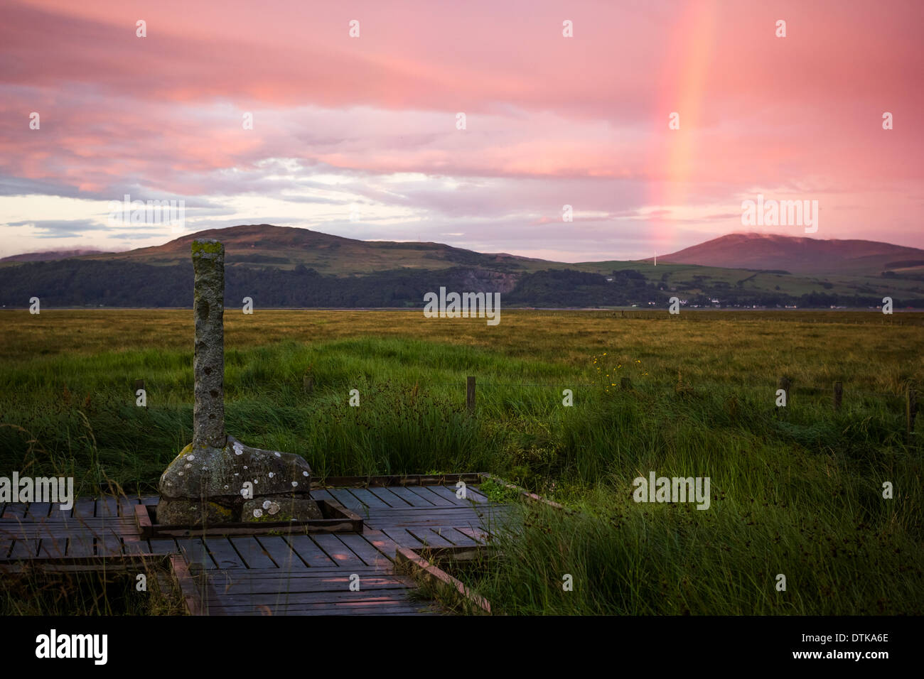 A warm coloured sunset with a rainbow at the Martyrs stone in Wigtown ...