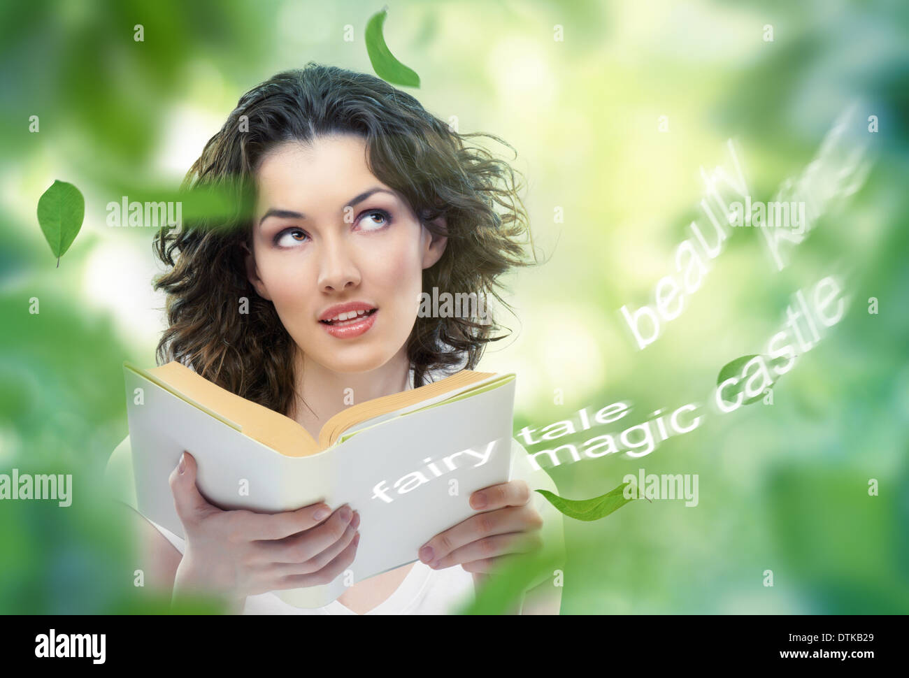 young beautiful girl reading a magic book Stock Photo - Alamy