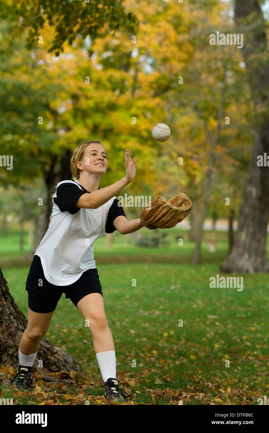 A female softball player catching a ball Stock Photo - Alamy