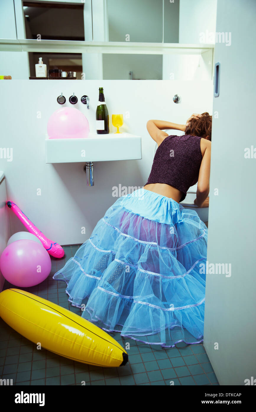 Woman vomiting into toilet hi-res stock photography and images - Alamy
