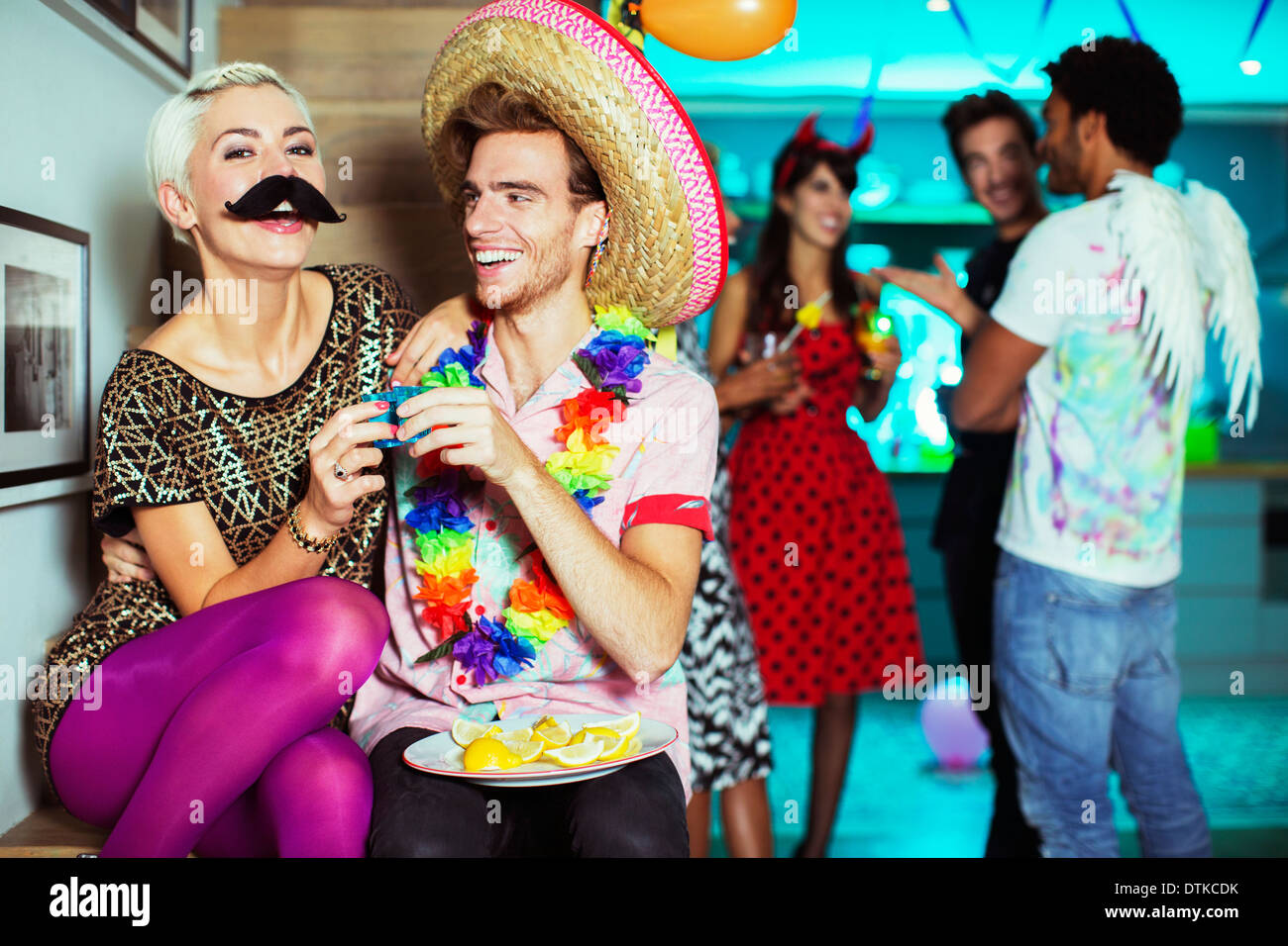 Couple wearing costumes at party Stock Photo - Alamy