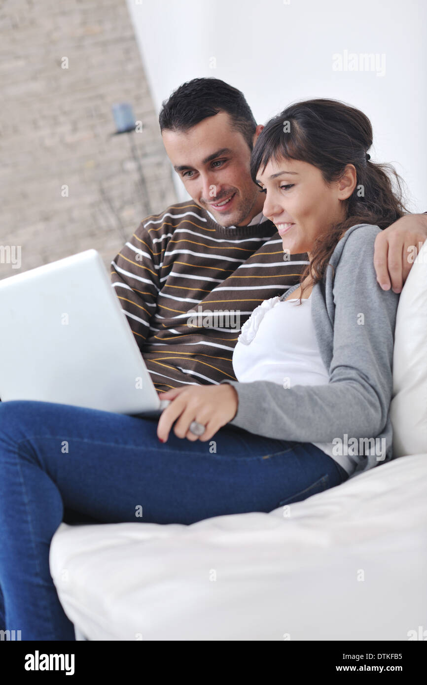 joyful couple relax and work on laptop computer at modern home Stock ...