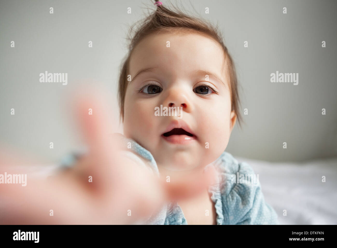 Baby girl reaching out Stock Photo - Alamy