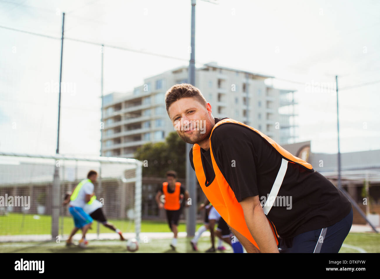 Soccer player smiling on field Stock Photo - Alamy