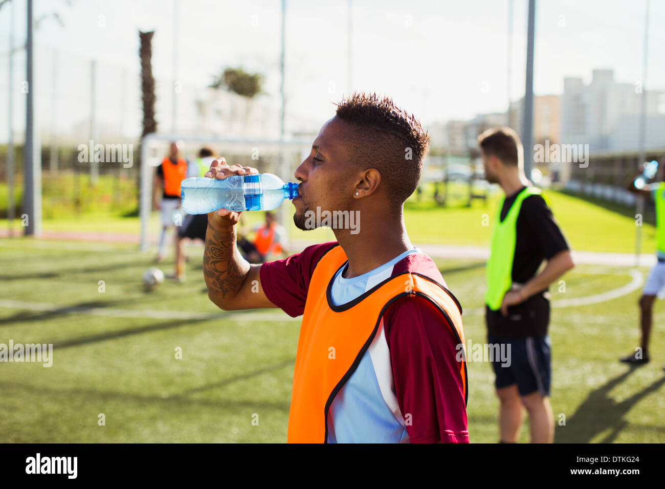 Soccer player drinking water on field Stock Photo - Alamy