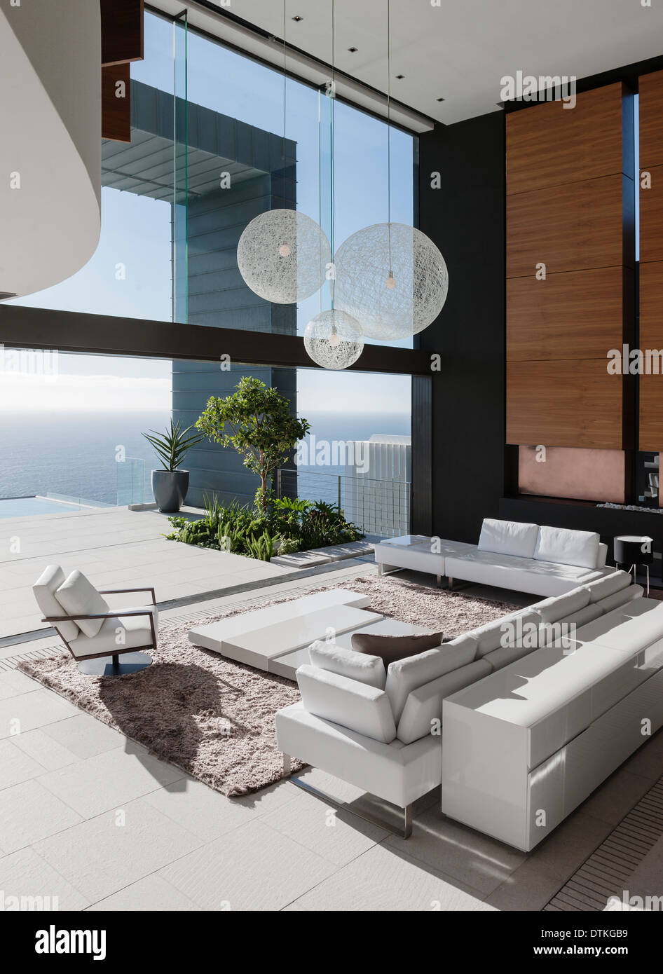 Modern living room overlooking ocean Stock Photo - Alamy