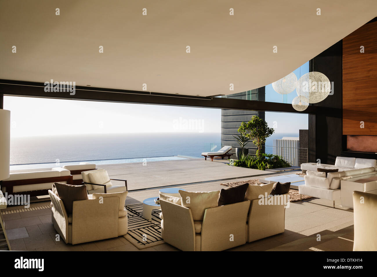 Modern living room overlooking ocean Stock Photo - Alamy