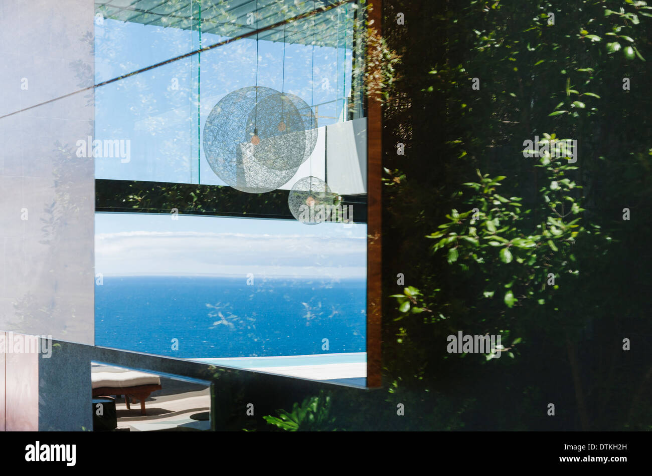 Reflection on window overlooking ocean Stock Photo - Alamy