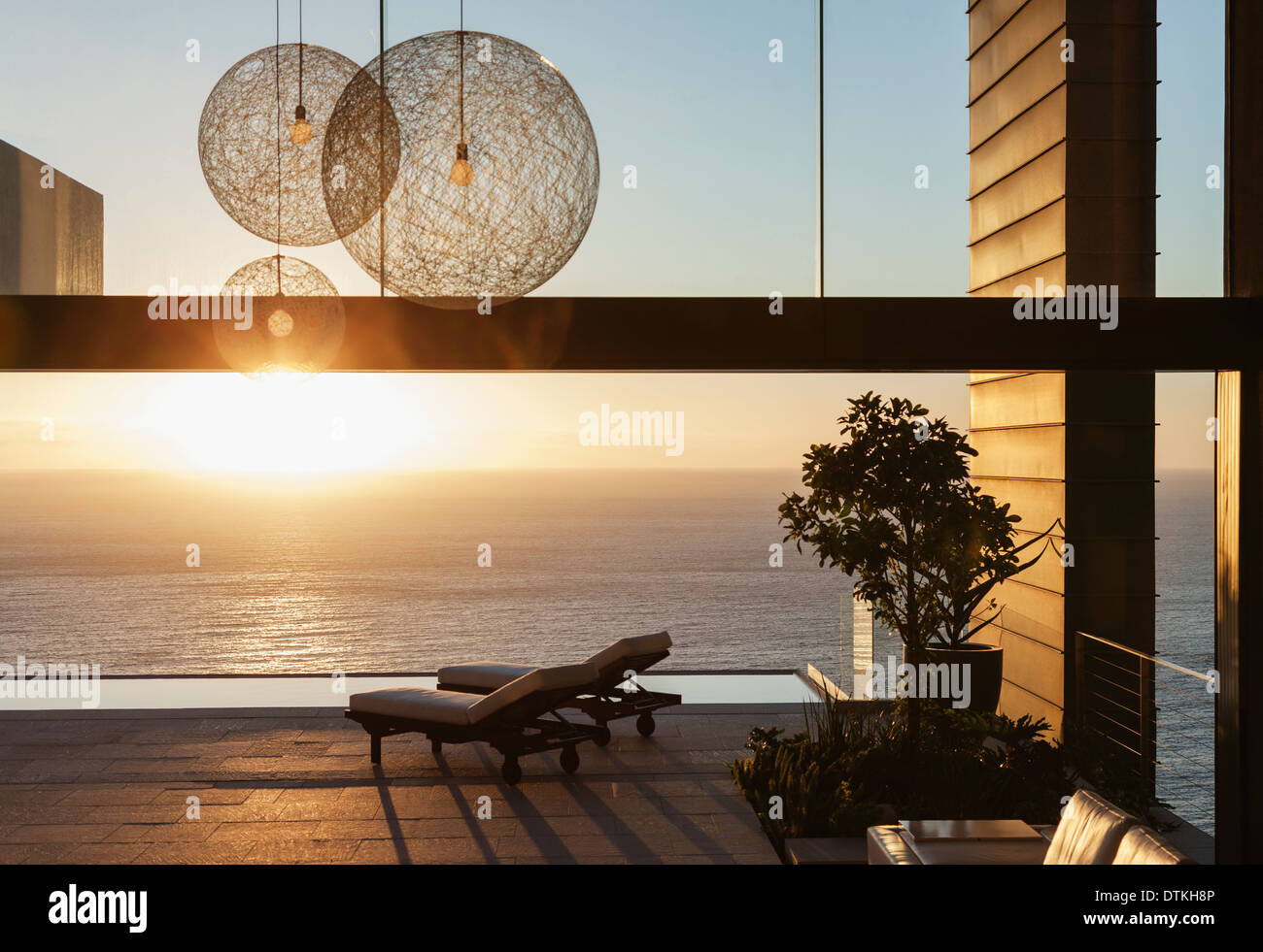 Patio of modern house overlooking ocean at sunset Stock Photo - Alamy