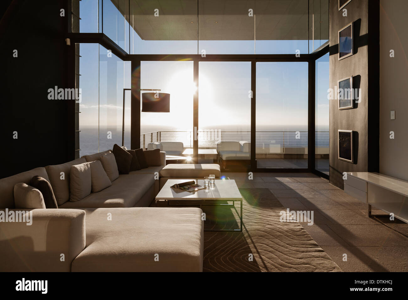 Modern living room overlooking ocean Stock Photo - Alamy