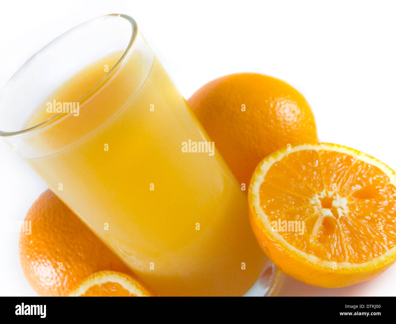 closeup orange juice and few oranges on white Stock Photo - Alamy