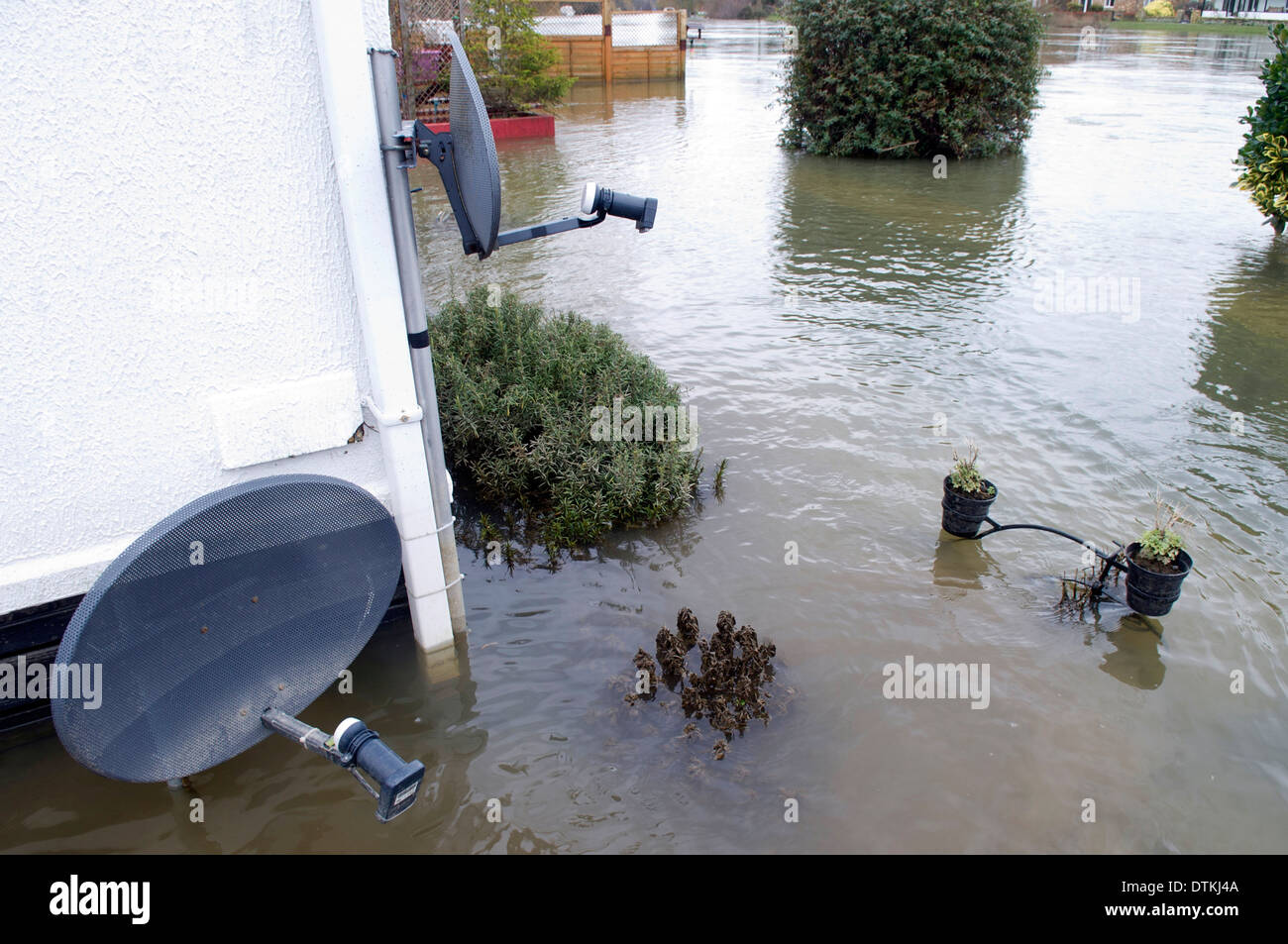 Prefabricated housing flooded along the Thames. Round black satellite ...