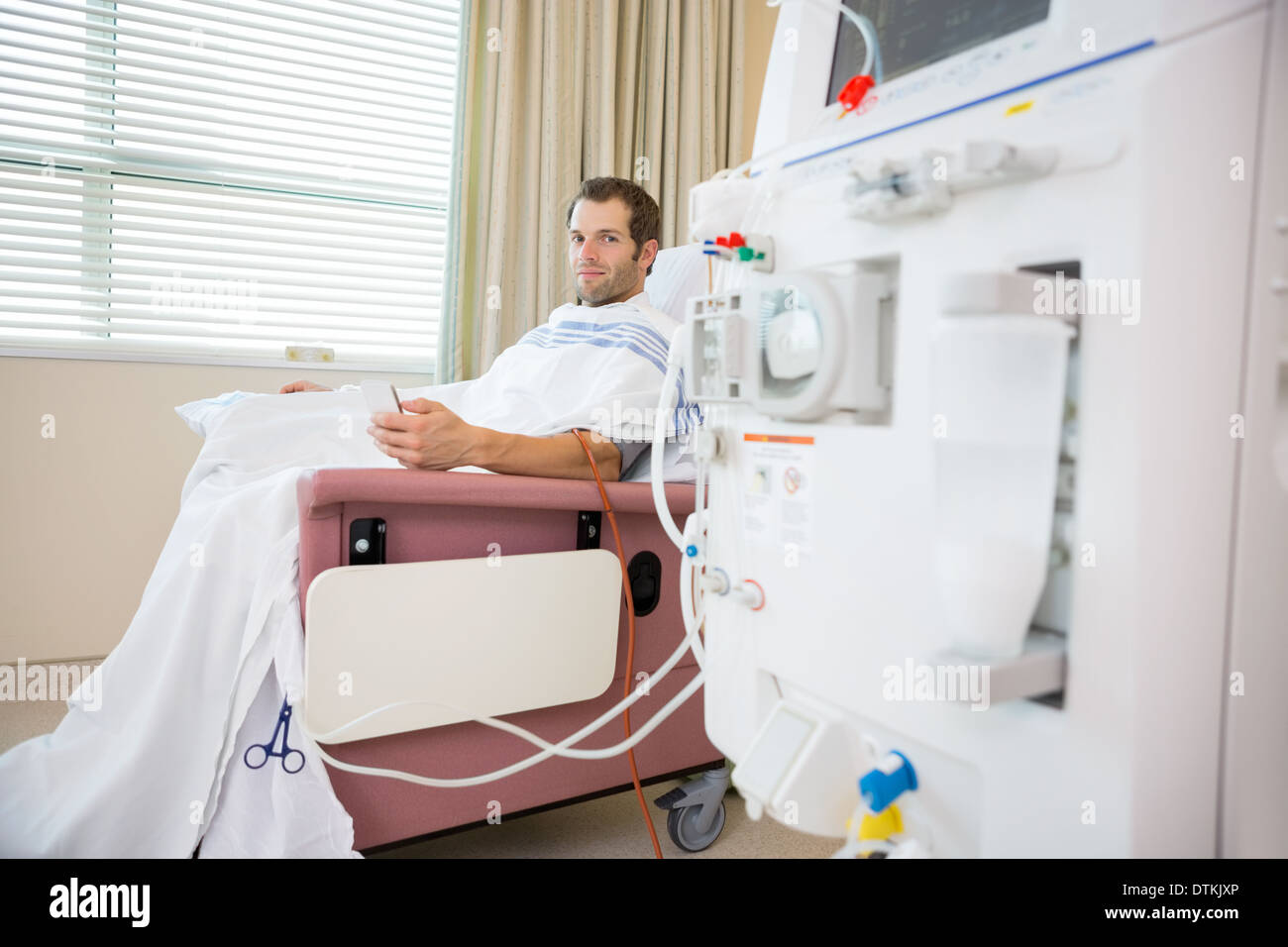 Patient Holding Cellphone During Renal Dialysis Treatment Stock Photo ...