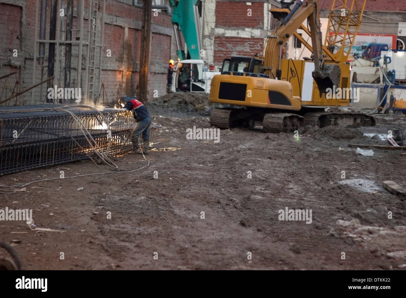 workers and diggers working in the construction field Stock Photo - Alamy