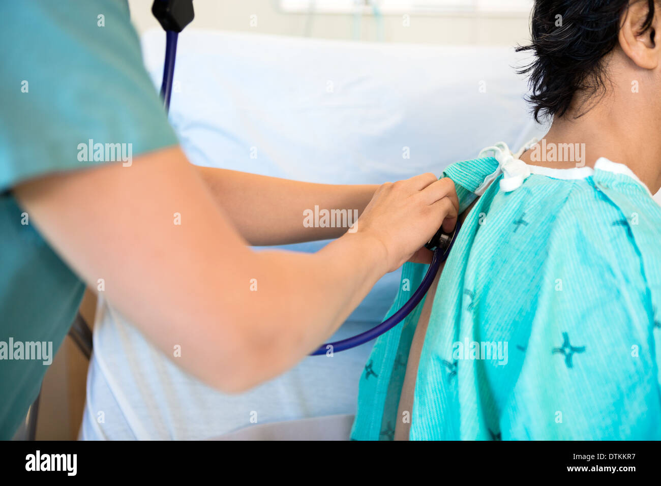 Female Nurse Examining Patient's Back With Stethoscope Stock Photo - Alamy