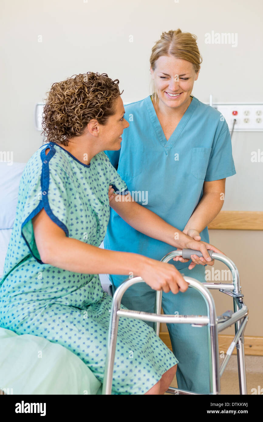 Nurse Assisting Patient Using Walker In Hospital Stock Photo - Alamy