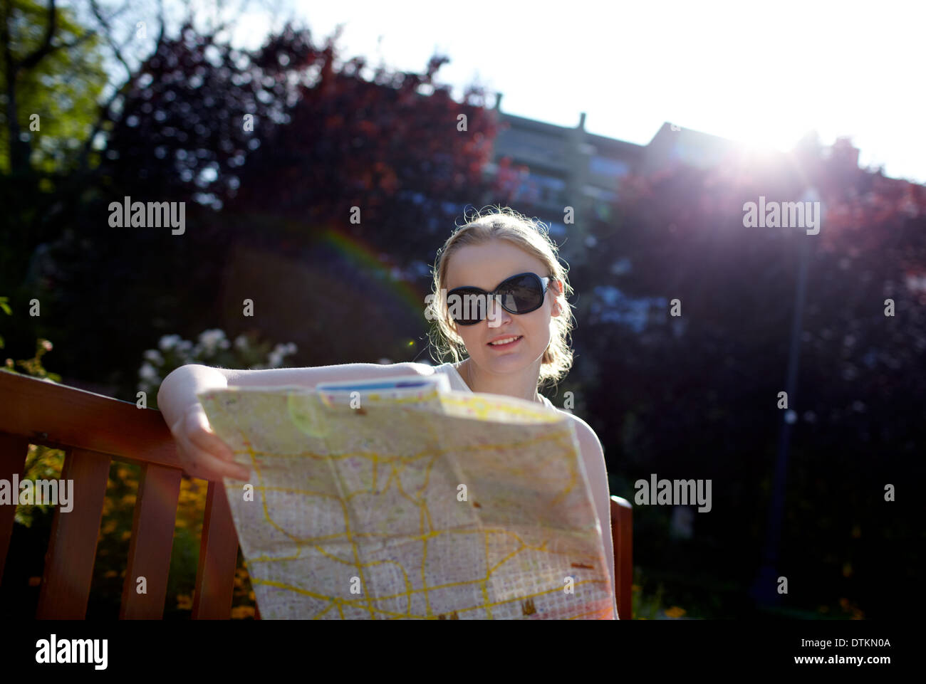 Girl reads the map outside Stock Photo - Alamy