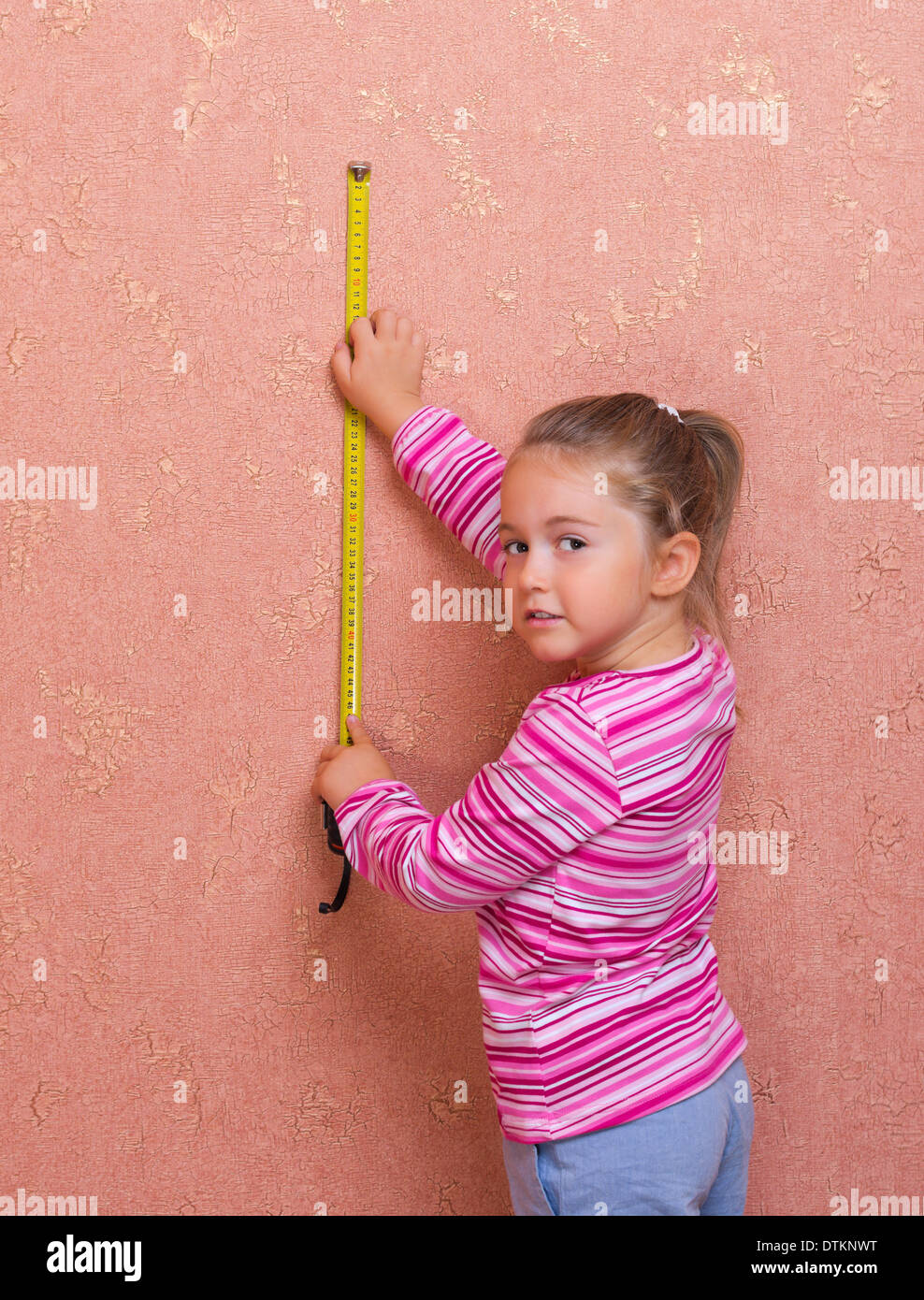 Little smiling girl with measurement tape Stock Photo - Alamy