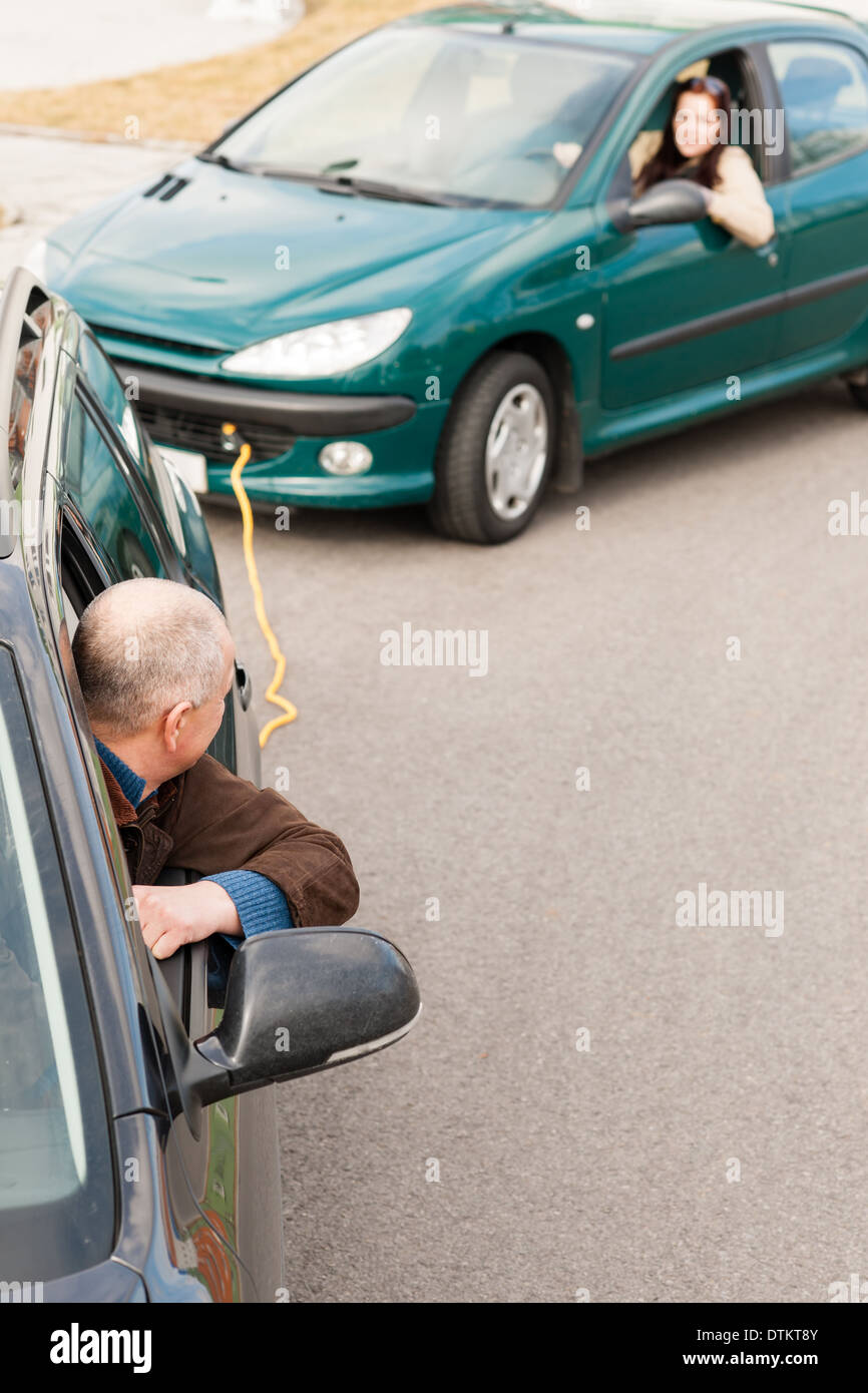 Man helping woman by pulling her car Stock Photo - Alamy
