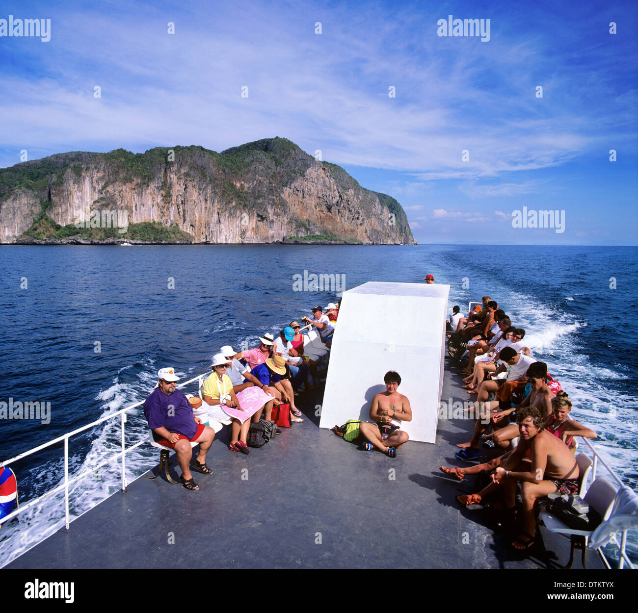 Tourists on Island boat cruise showing ocean rock formation in ...