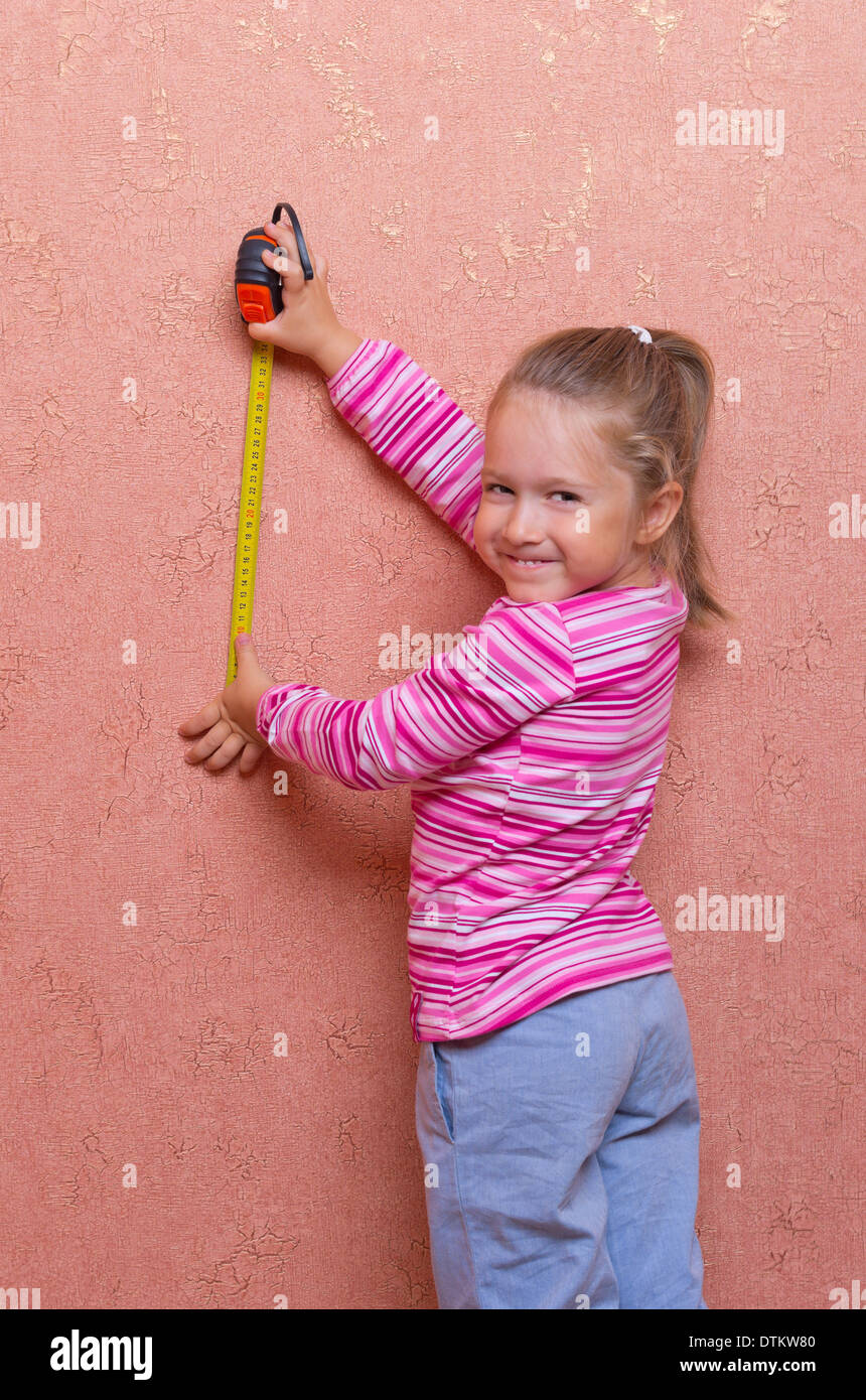 Little smiling girl with measurement tape Stock Photo - Alamy