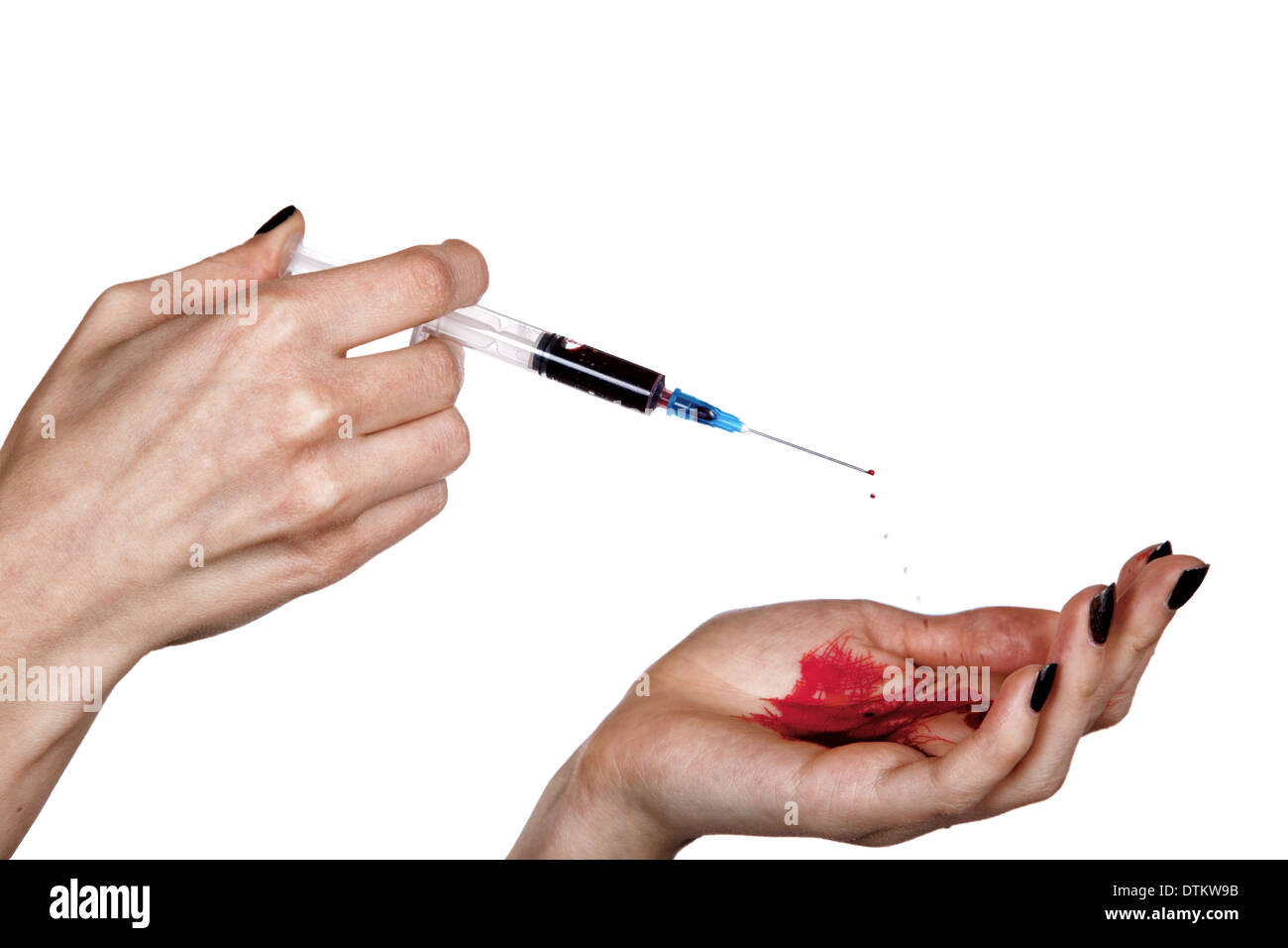 Hands of the addict about a syringe isolated on a white background ...