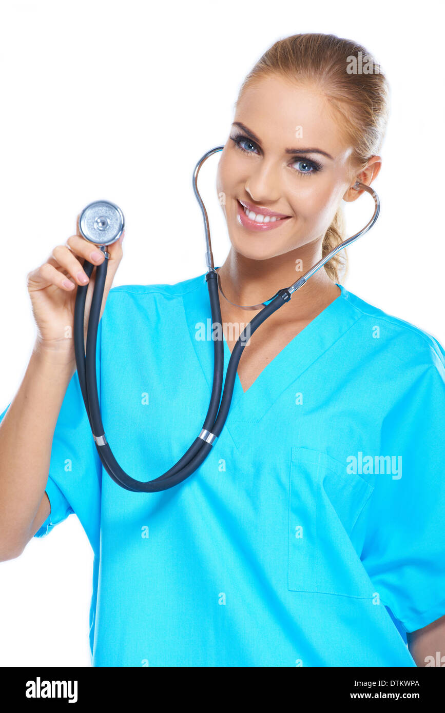Pretty young doctor holding her stethoscope while isolated Stock Photo ...