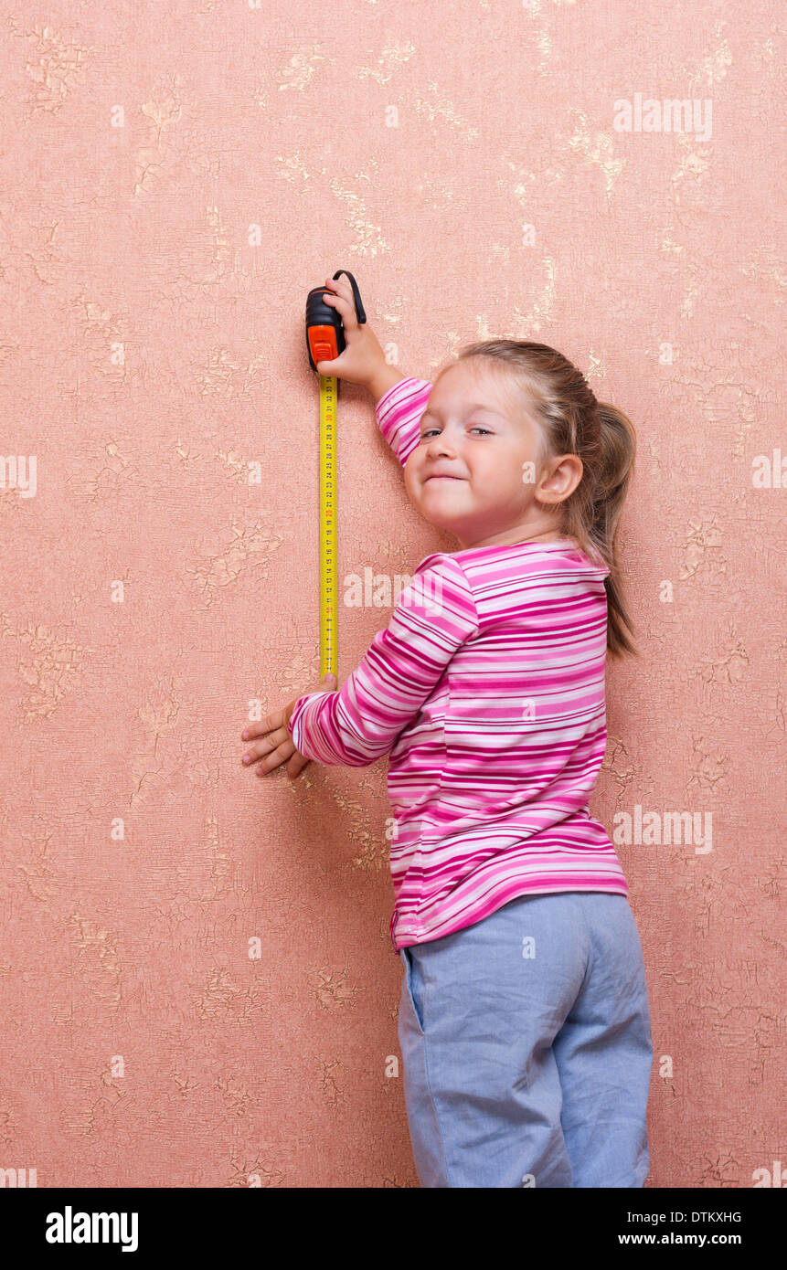 Little girl with measure tape Stock Photo - Alamy