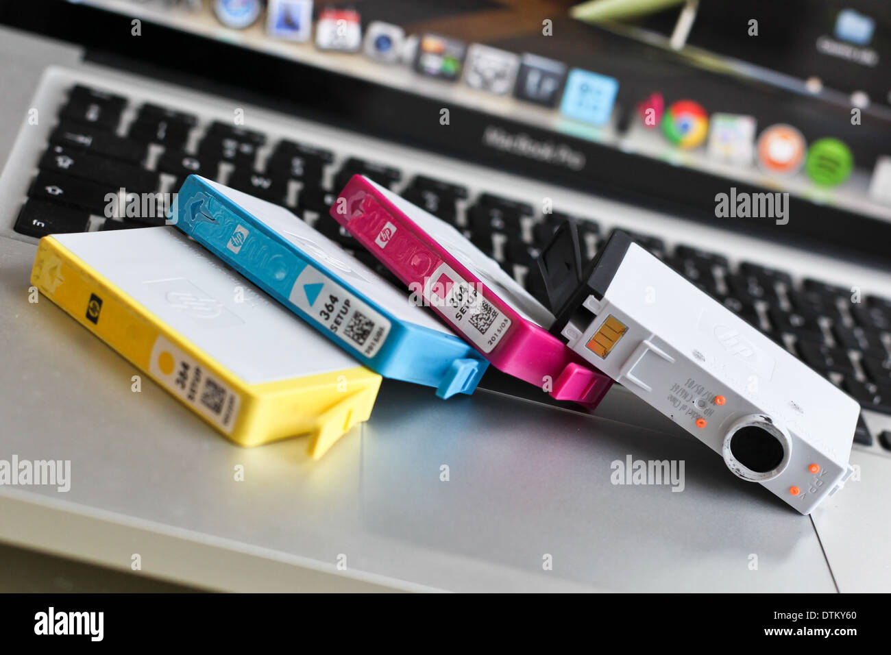 A set of inkjet printer cartridges on an Apple laptop computer Stock ...