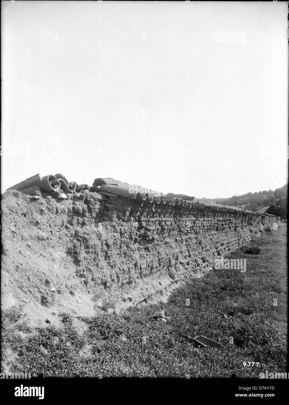 The photograph shows the ruins of an adobe wall at Mission San Antonio ...
