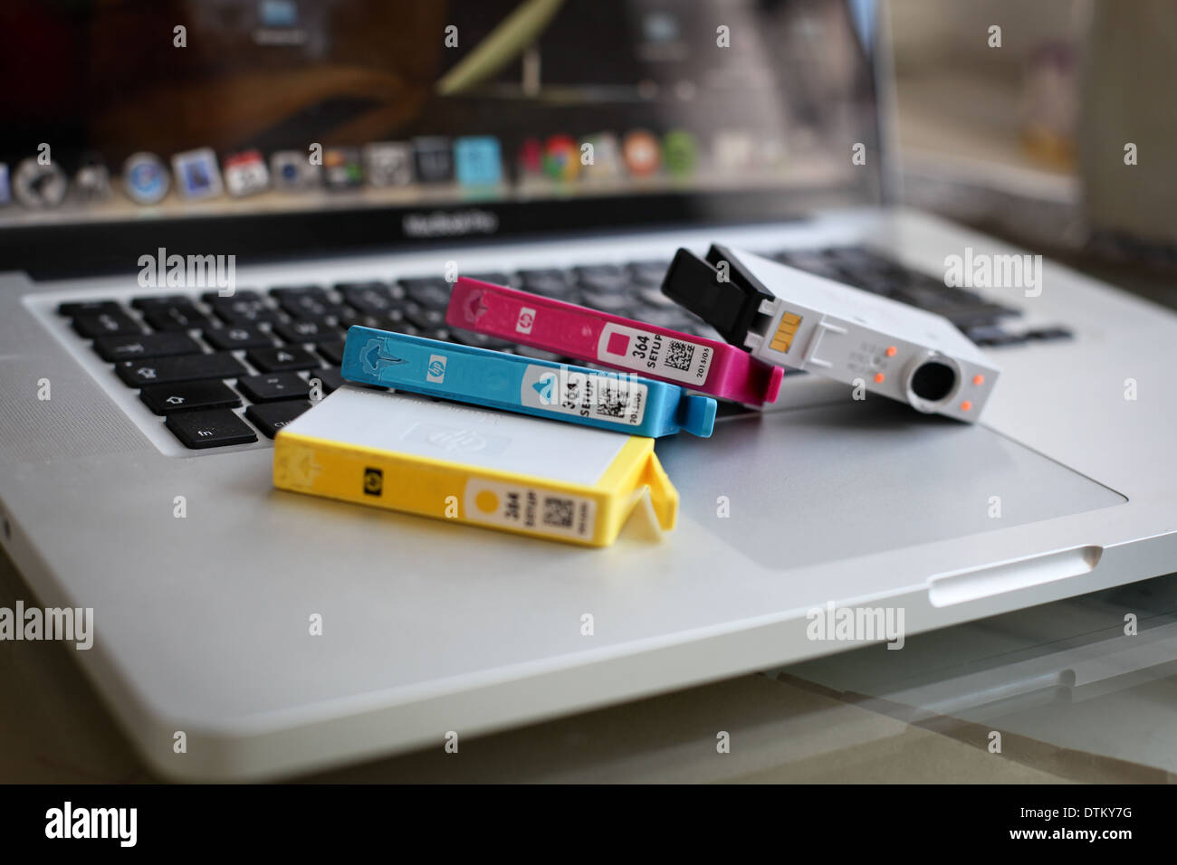 A set of inkjet printer cartridges on an Apple laptop computer Stock ...