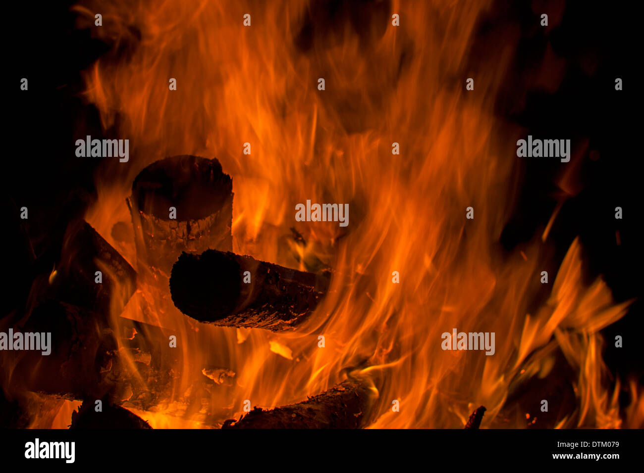 Logs in the fire on a black background Stock Photo - Alamy