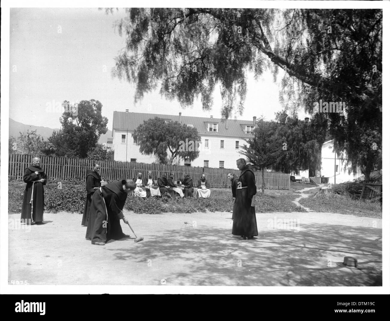 A photograph of six Franciscan monks observing five others playing ...