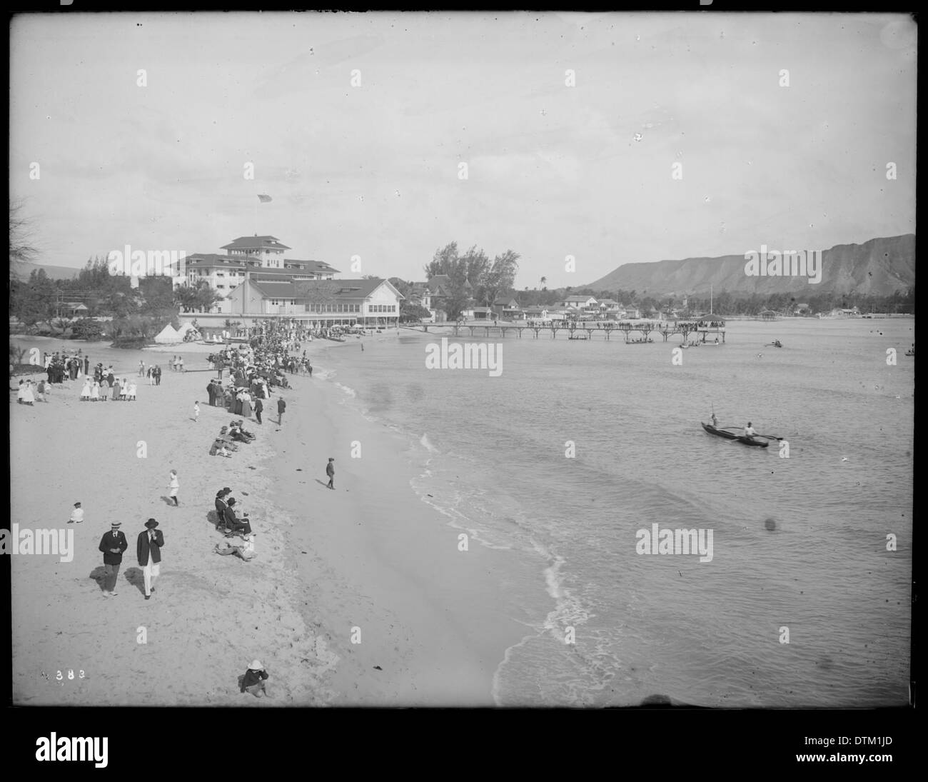 Small crowds of people walking along Waikiki Beach, Honolulu, Hawaii ...