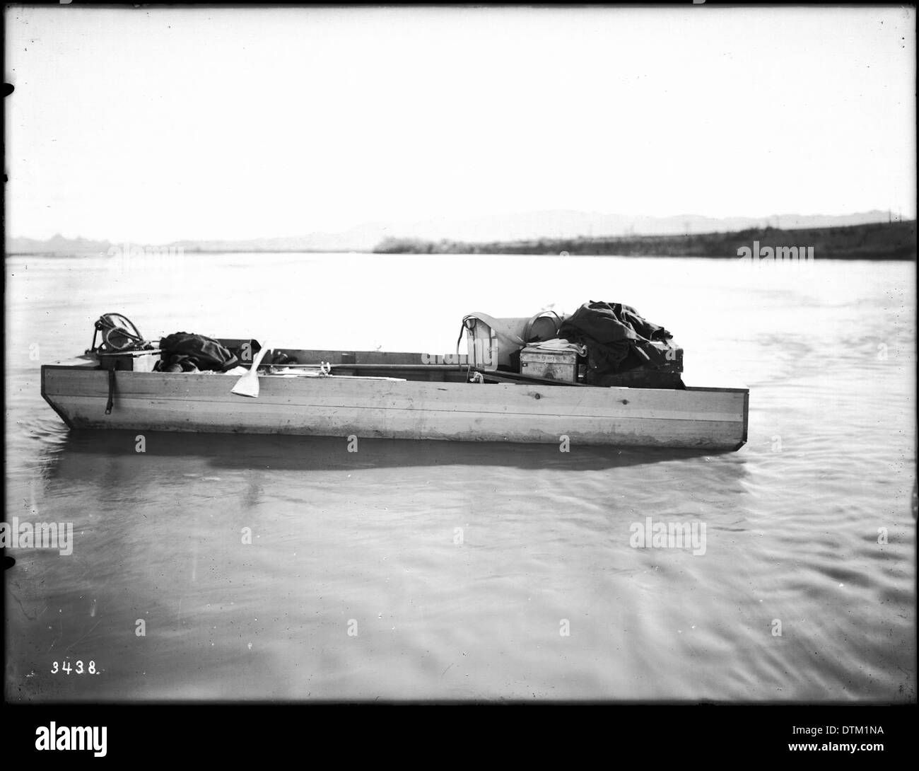 This photograph from around 1900 depicts a small outboard boat stranded ...
