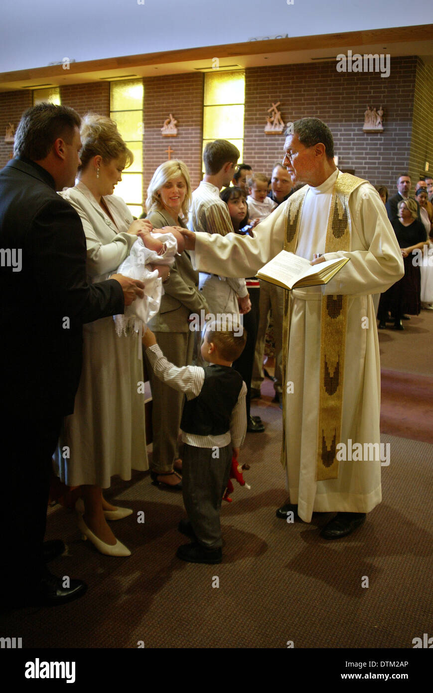 Priest christening baby in church hi-res stock photography and images - Alamy