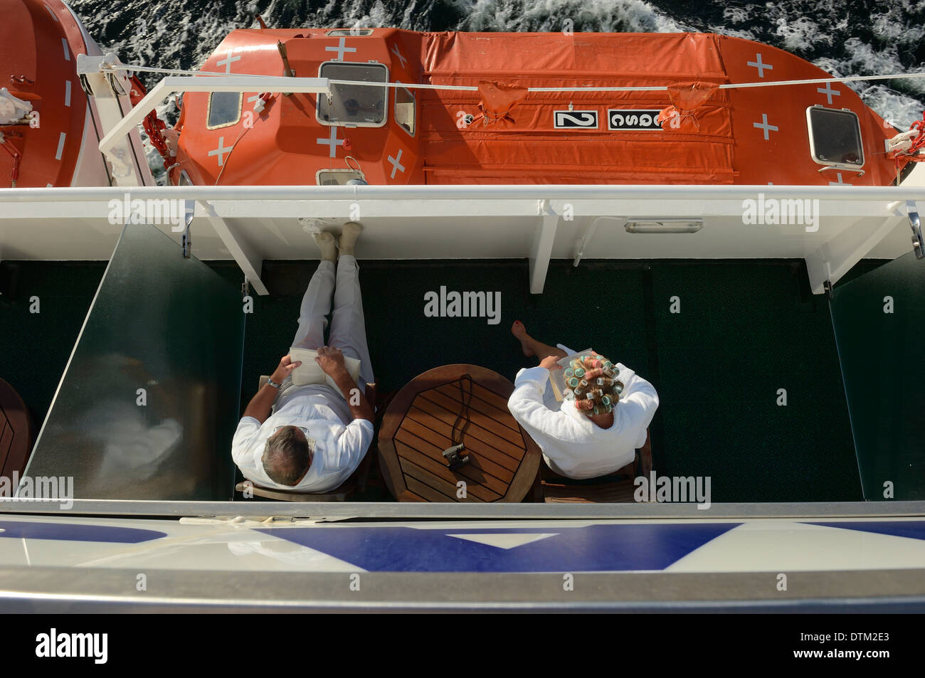 Cruise ship passengers reading books on their private balcony. Baltic ...
