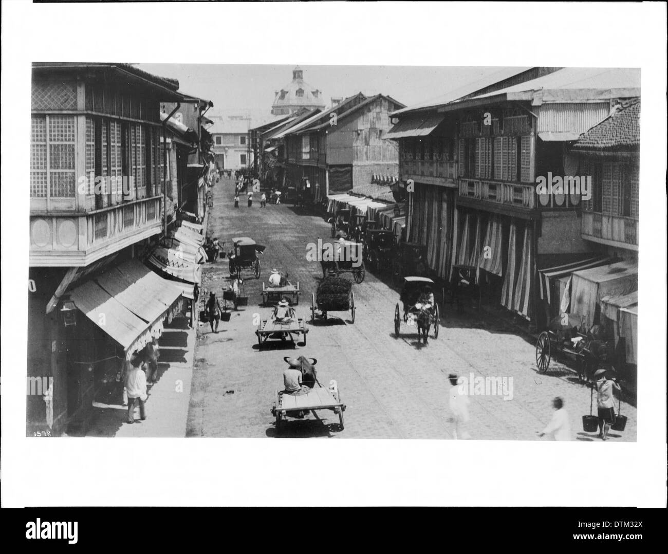 This photograph depicts a street scene in Manila, Philippines, taken ...