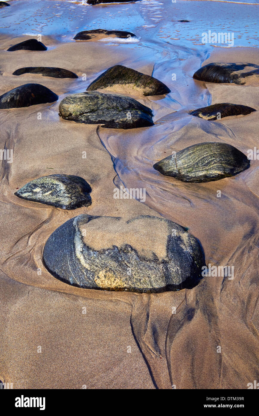 Smooth, rounded rocks on a beach on South Uist, Outer Hebrides ...