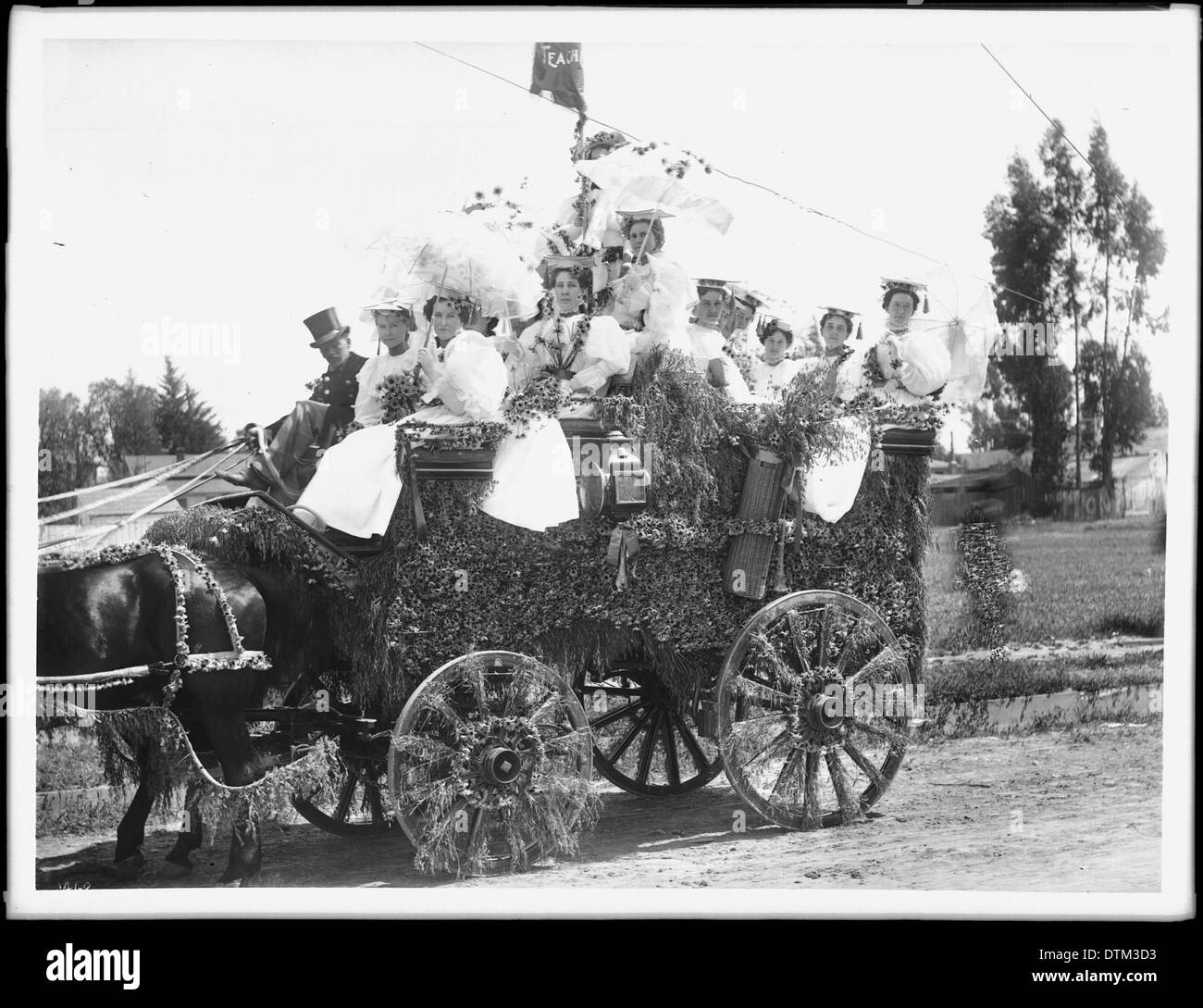 A photograph of teachers riding a Tally-ho (horse-drawn carriage ...