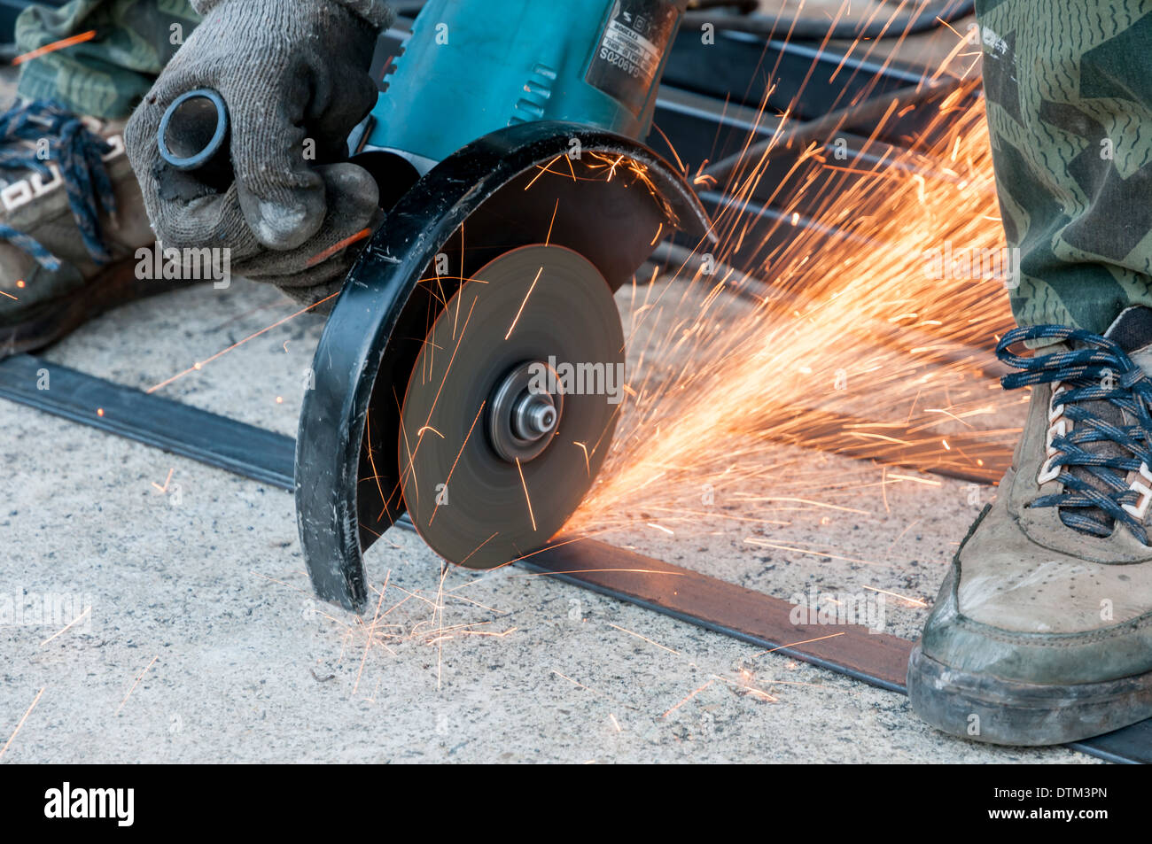 Worker with angle grinder Stock Photo - Alamy