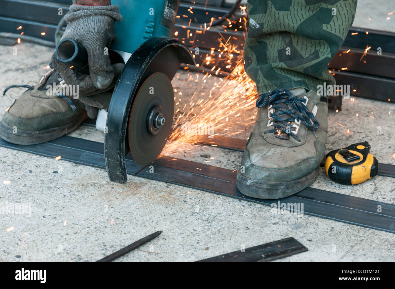 Worker with angle grinder Stock Photo - Alamy