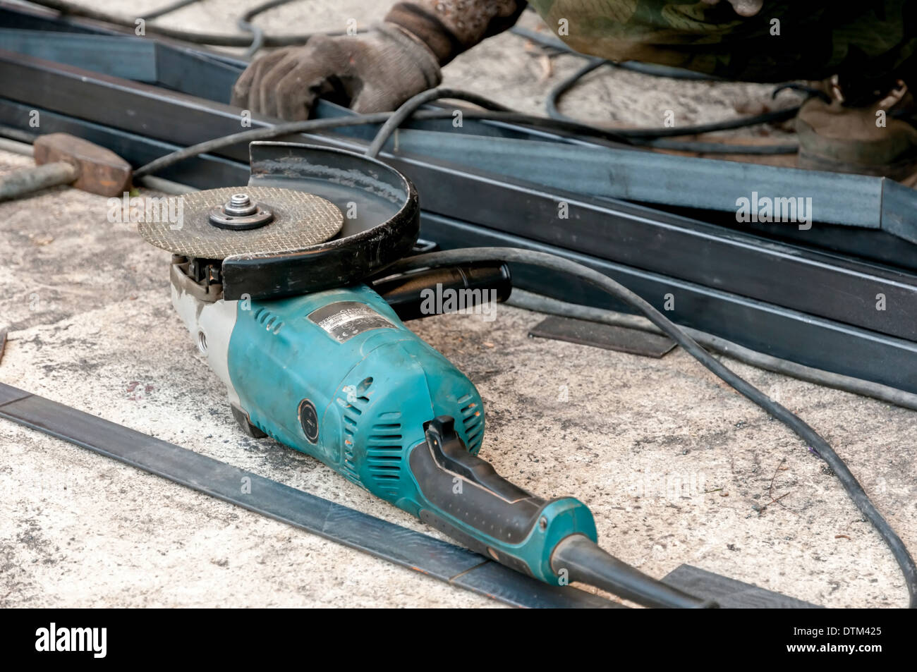 Worker with angle grinder Stock Photo - Alamy