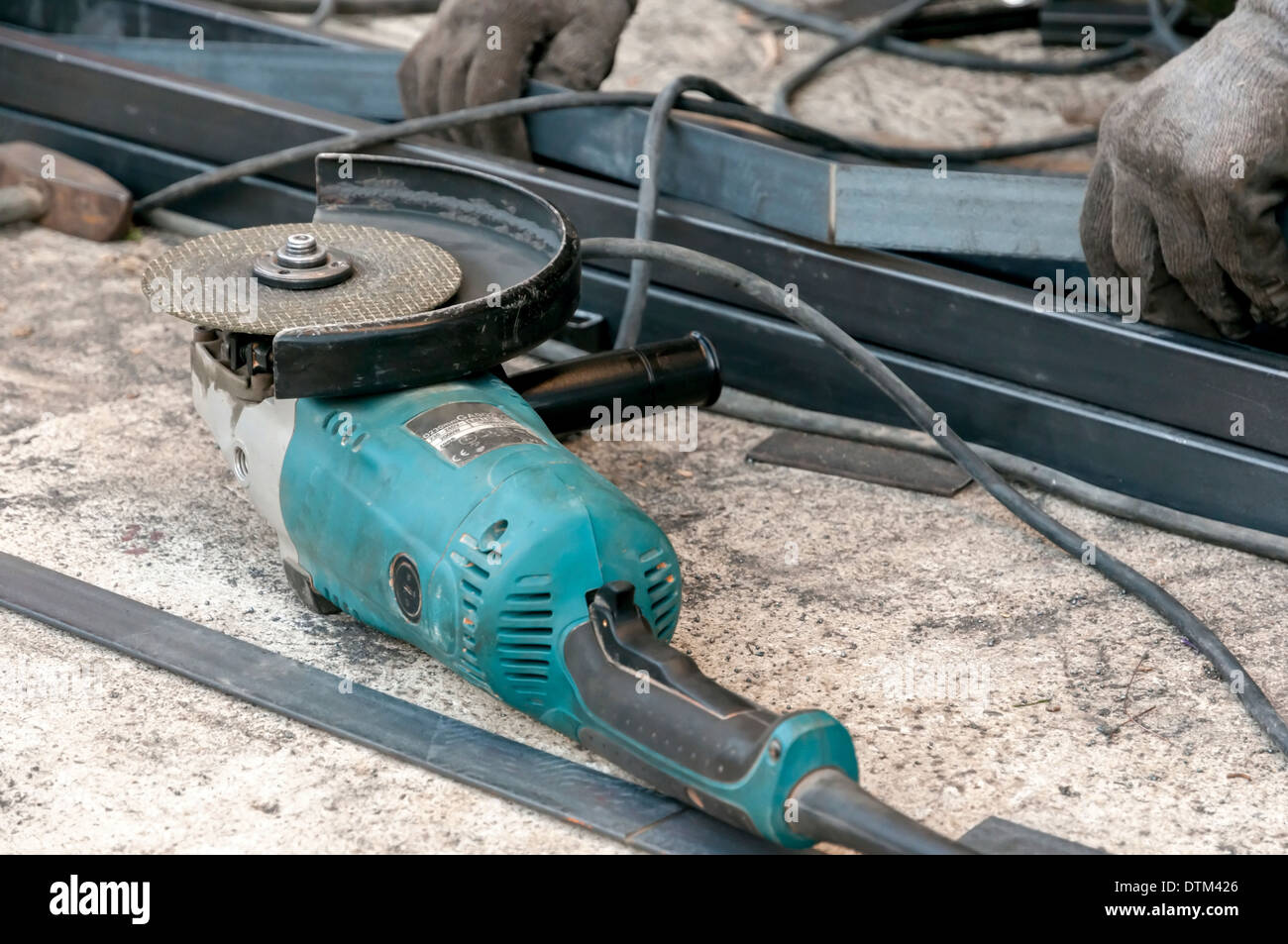 Worker with angle grinder Stock Photo - Alamy