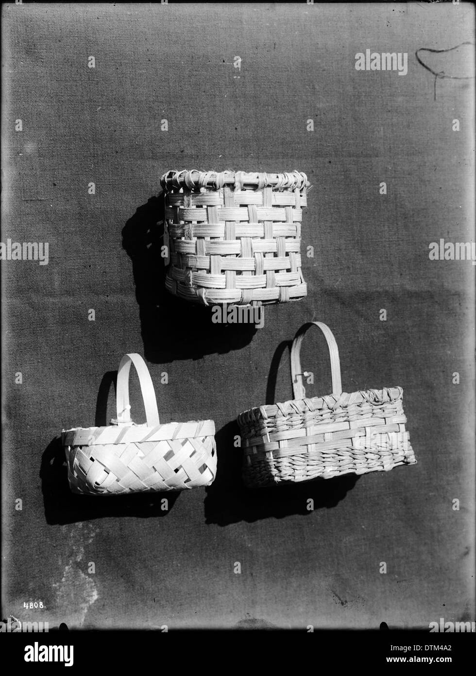 A photograph of three traditional Native American baskets displayed ...