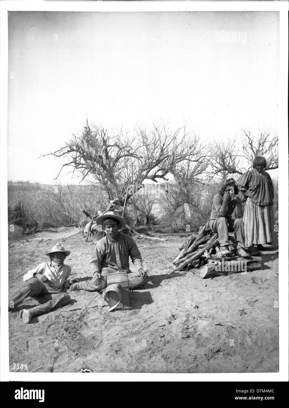 Three young Apache men and a woman are pictured at an Apache Indian ...