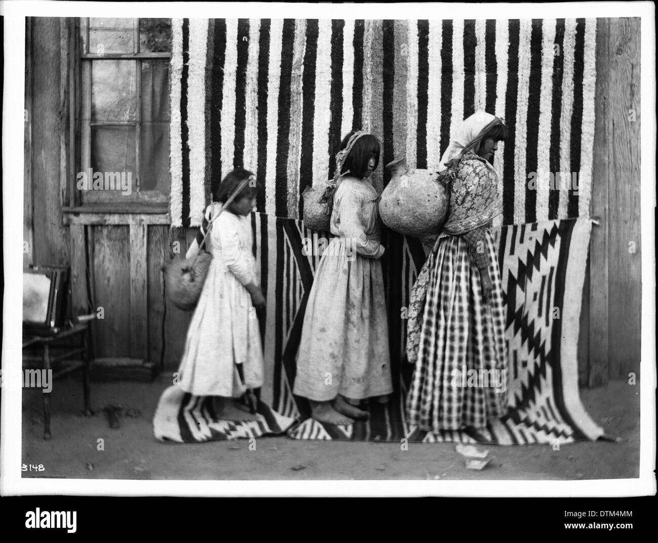 A photograph depicting three young Walapai Indian women carrying water ...
